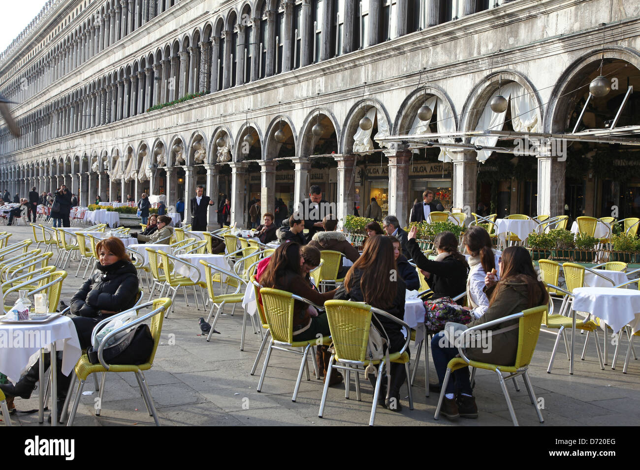 A waiter serving customers at one of the outdoor pavement cafes in St ...