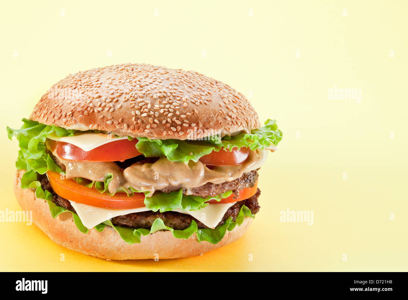 Hamburger on a yellow background Stock Photo - Alamy