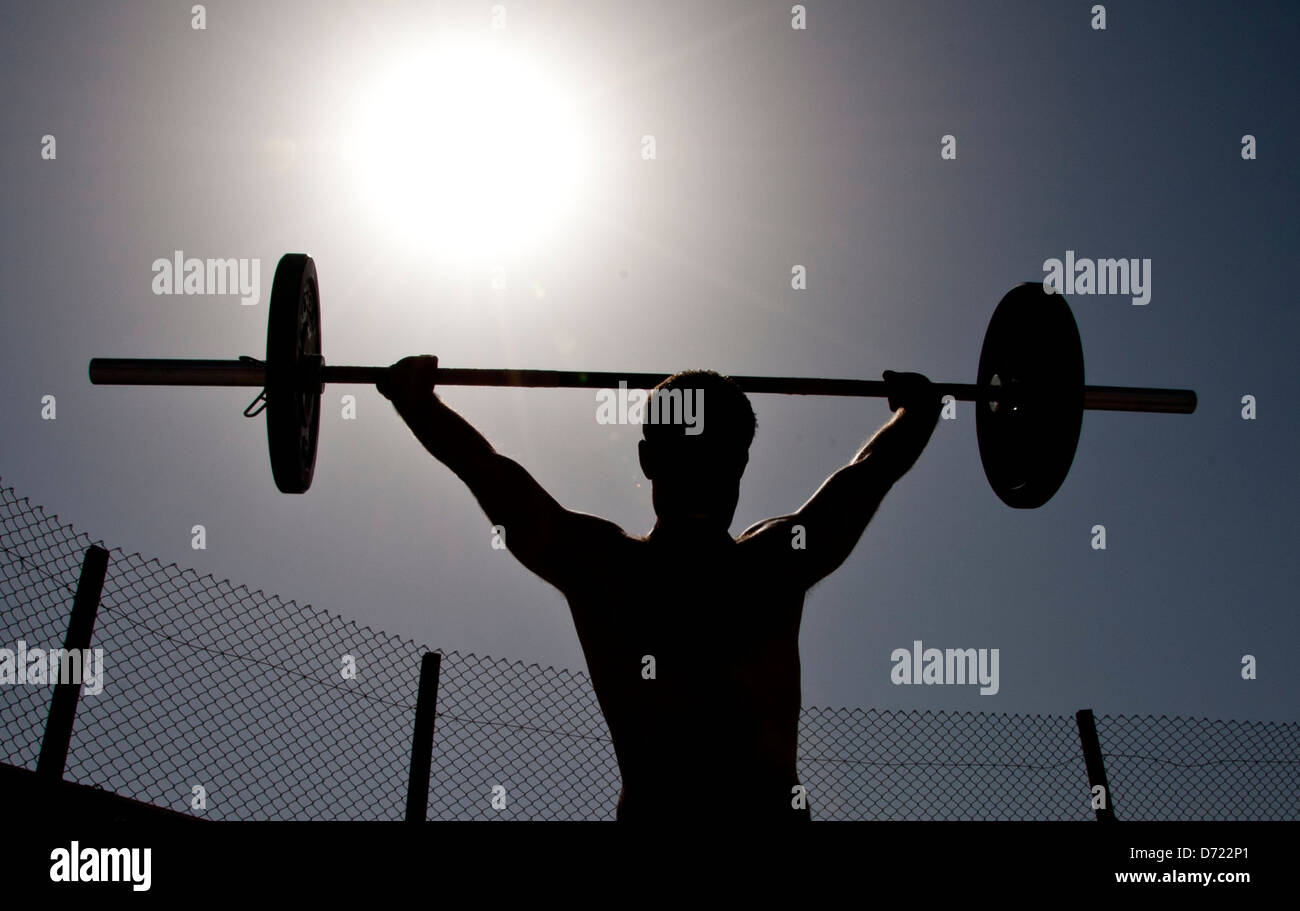 A man performing weight lifting, demonstrating strength and athleticism ...