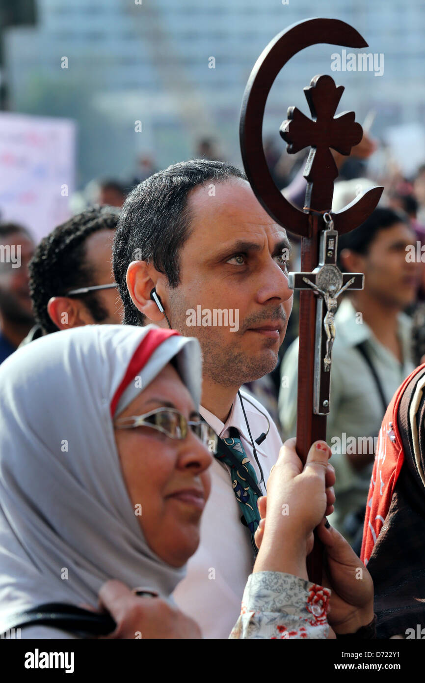 An Egyptian muslim-christian couple holds a cross during a mass rally ...