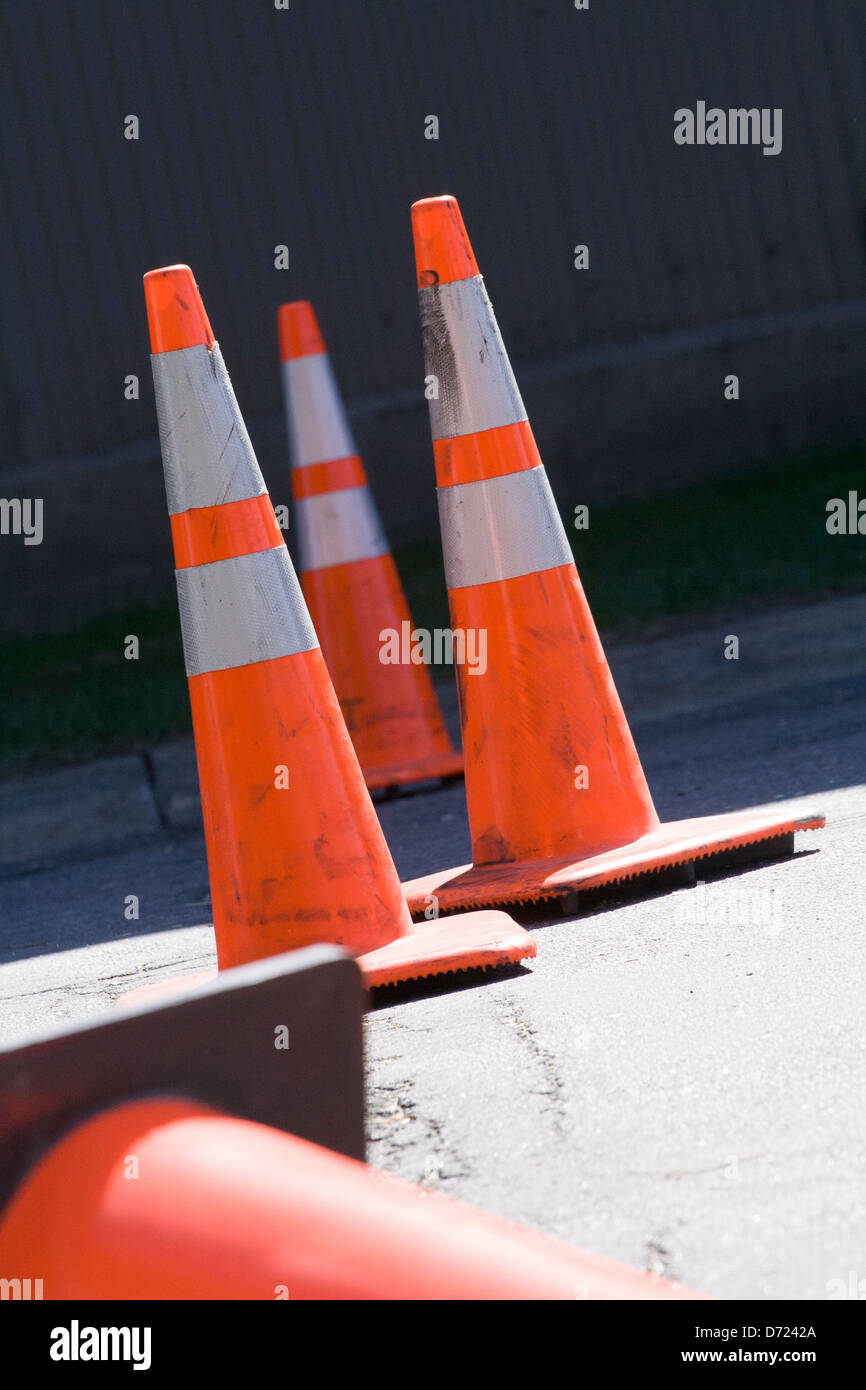 A line of orange cones in the one in the shadows and one knocked over ...