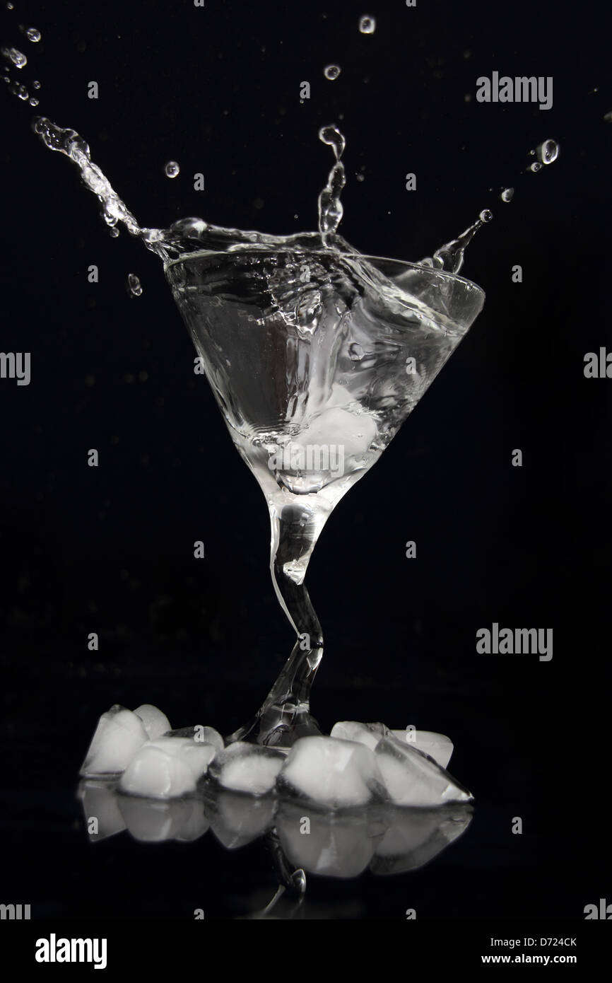 martini drink splash on black background Stock Photo - Alamy