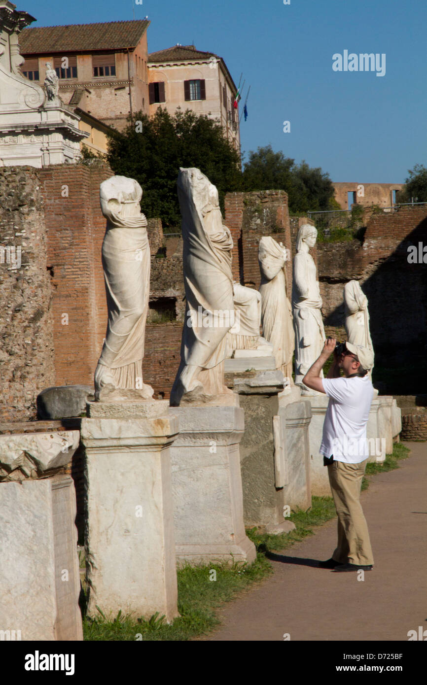 Tourist man visiting and recording video at statues in Roman Forum ...