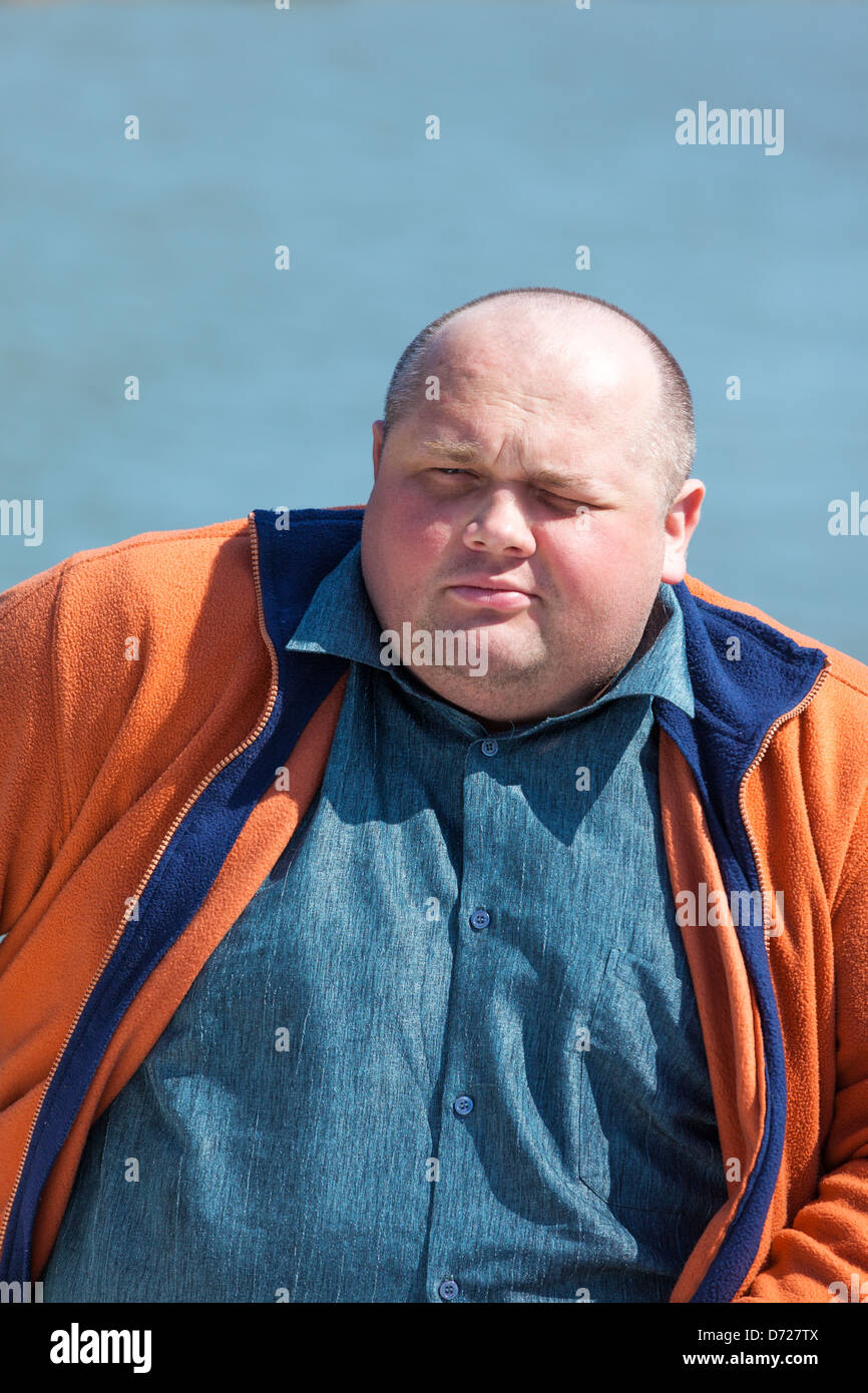 Portrait of a pretty fat man, on a background of water Stock Photo - Alamy
