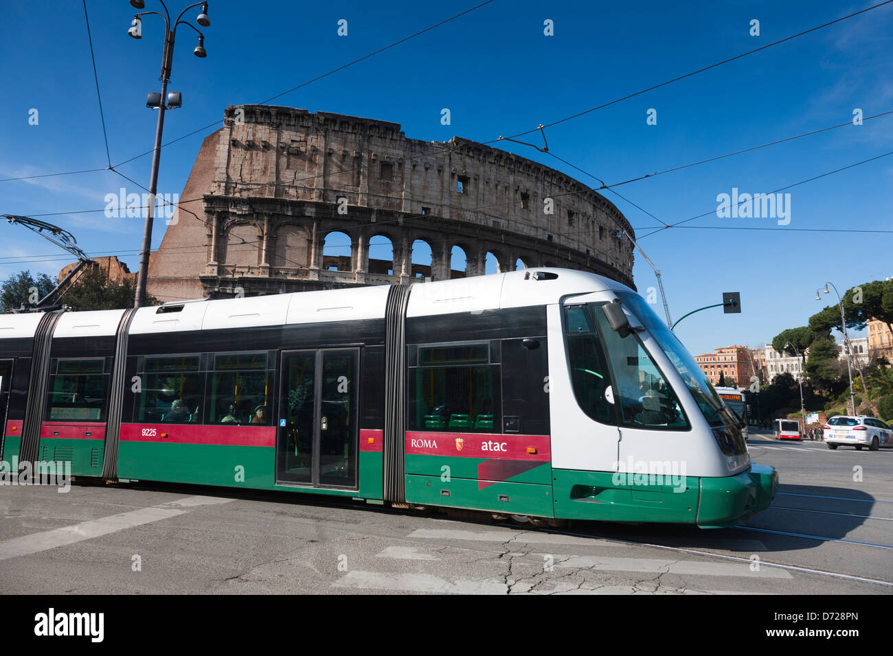 Tram in front of the Colosseum or Coliseum, also known as the Flavian ...