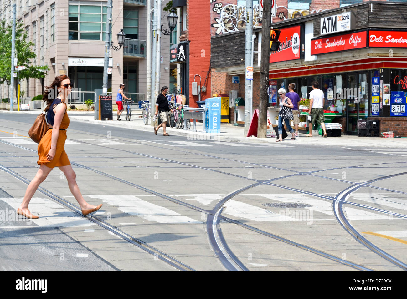 a girl crossing roads in downtown toronto Stock Photo - Alamy
