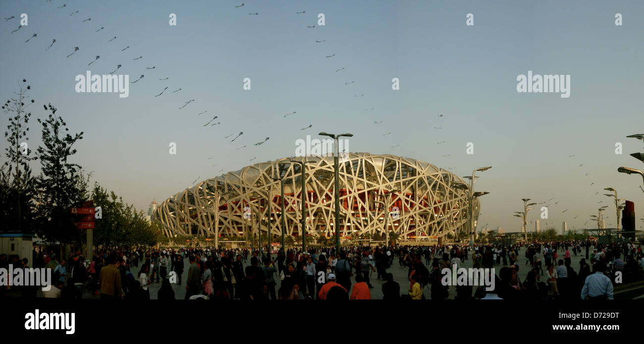Crowds of people and kites flying outside the Birds Nest stadium in ...