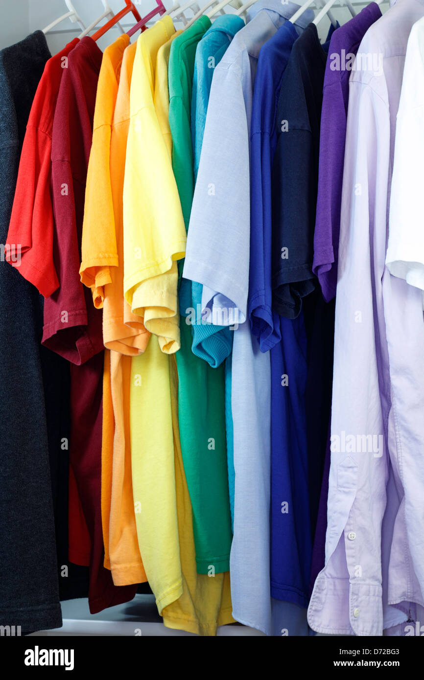 Colorful assortment of menswear shirts hanging from a clothes rack in a ...