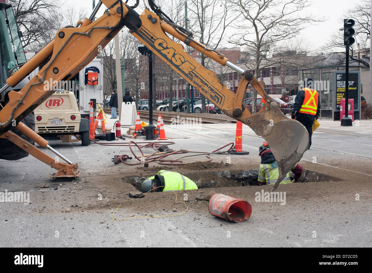 Workers repair underground problems on Beacon Street in Brookline ...