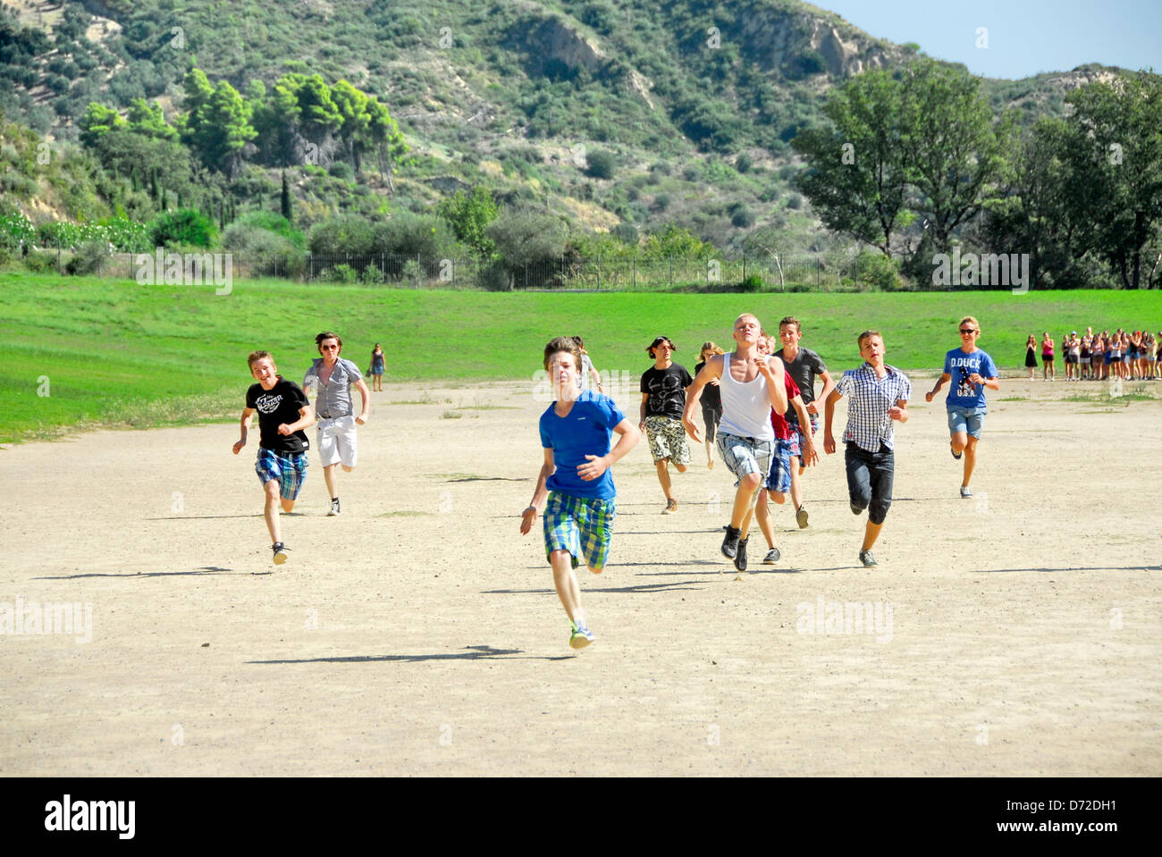 Young tourists recreating the running at the original Olympic Stadium ...