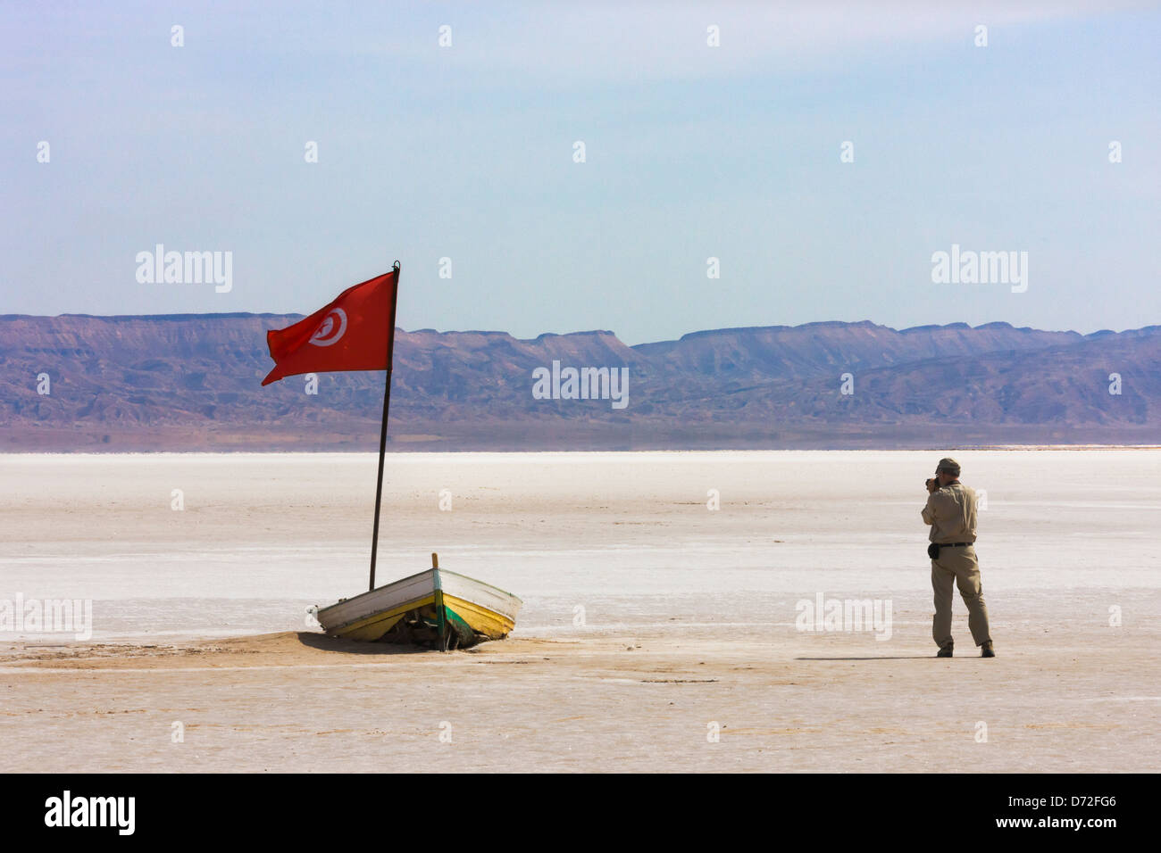 Tourist photographing Chott El Jerid (salt lake), near Tozeur, Tunisia ...