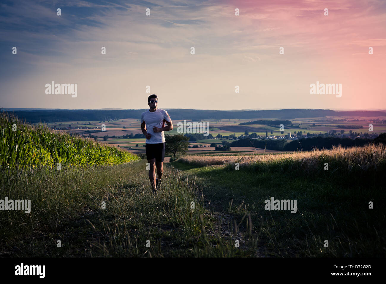 man jogging through the fields Stock Photo - Alamy