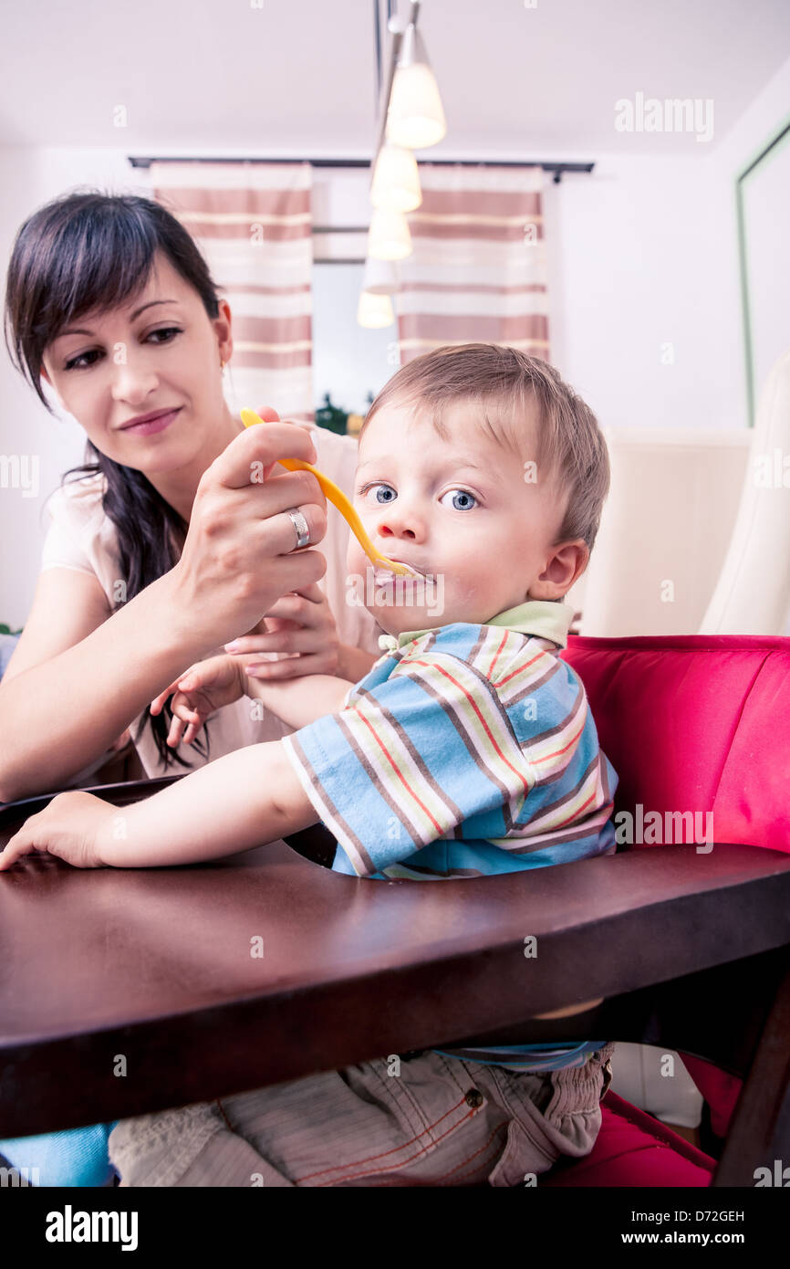 little child eating a yogurt Stock Photo - Alamy