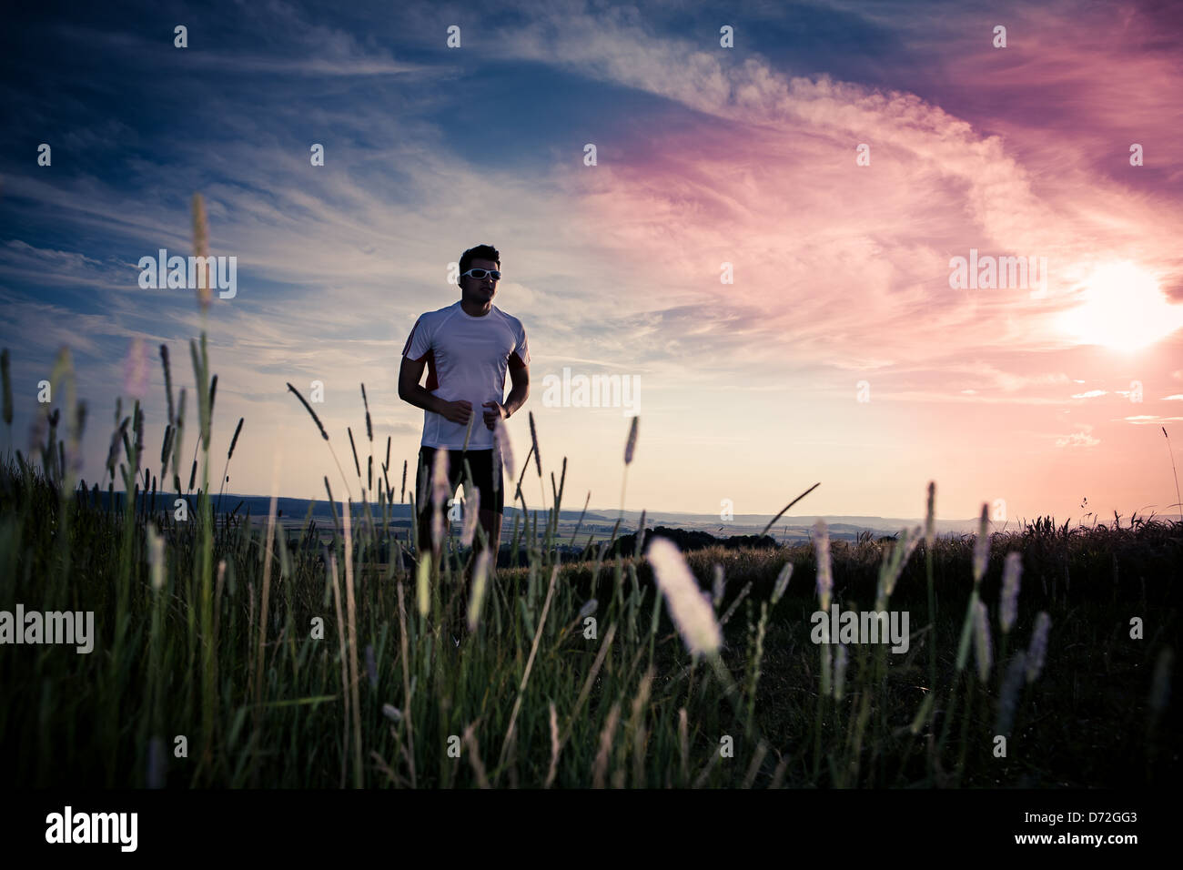 man jogging through the fields Stock Photo - Alamy