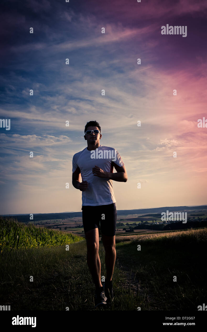 man jogging through the fields Stock Photo - Alamy