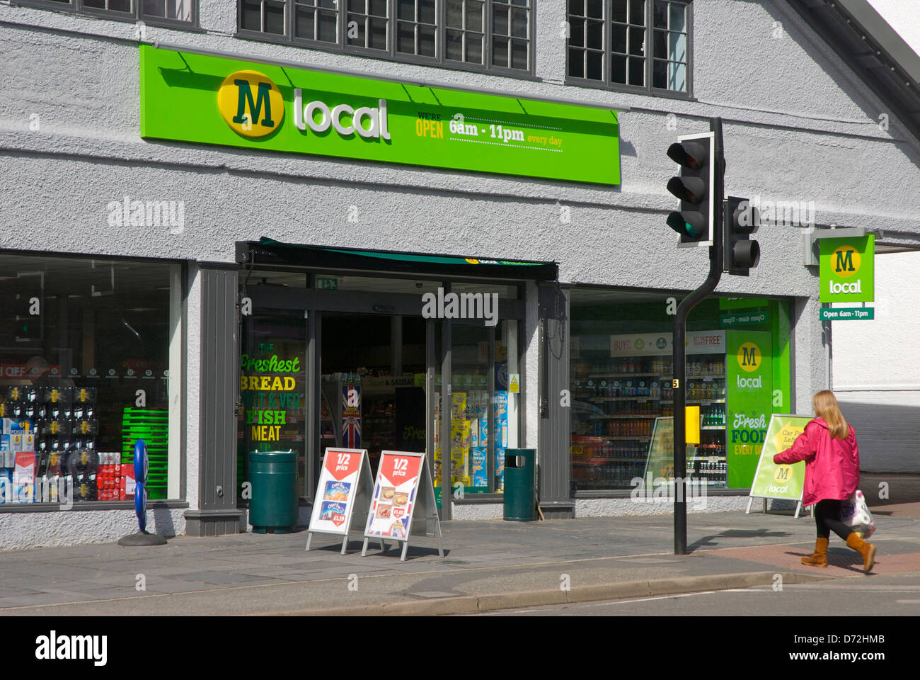 Woman going into M Local, a small branch of Morrisons, in Windermere ...
