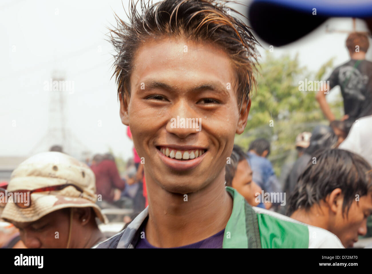 A young man smiles for a photo during the Thingyan Water Festival in ...