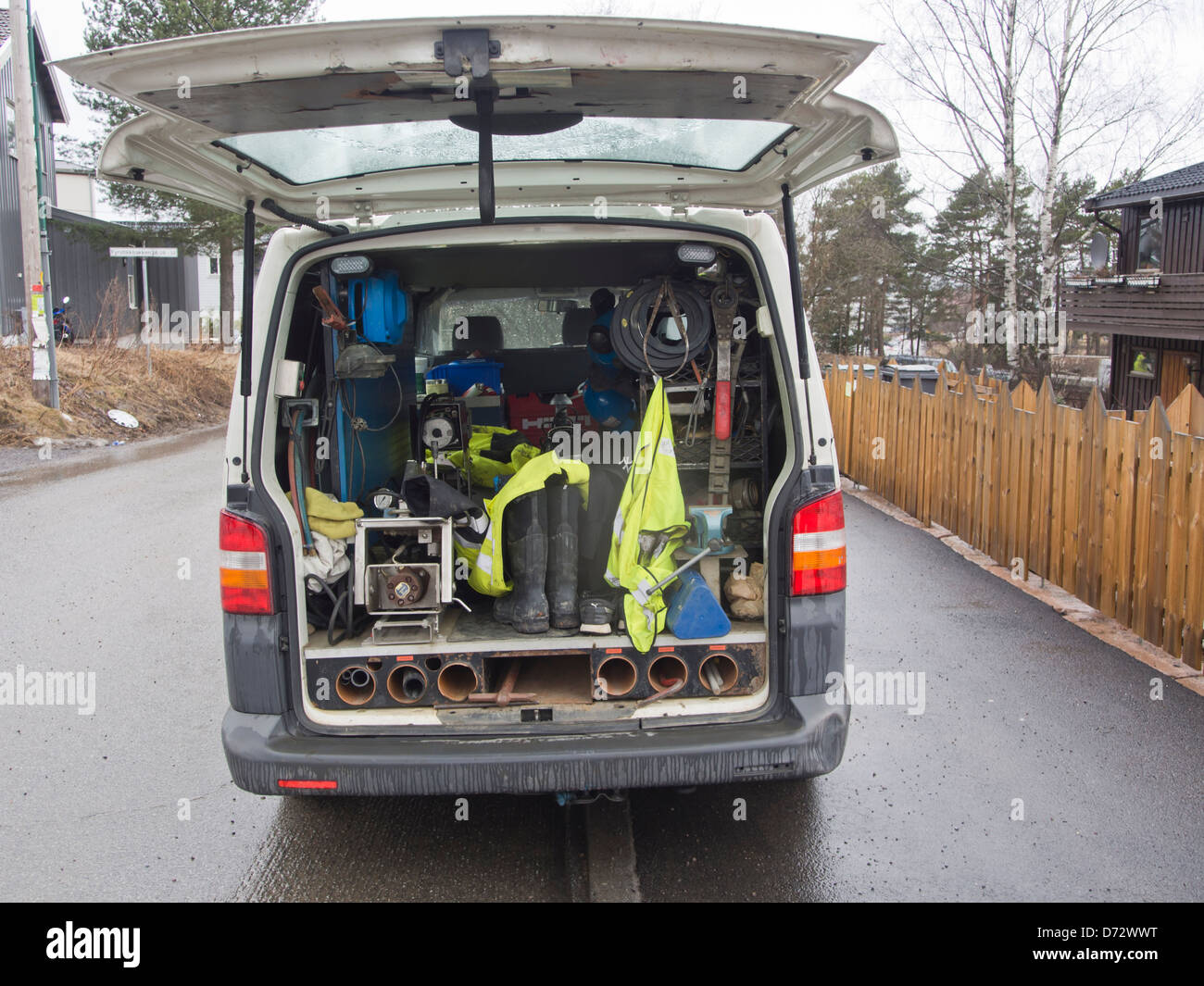 open back of van with equipment for water and sewage workers, parked in ...