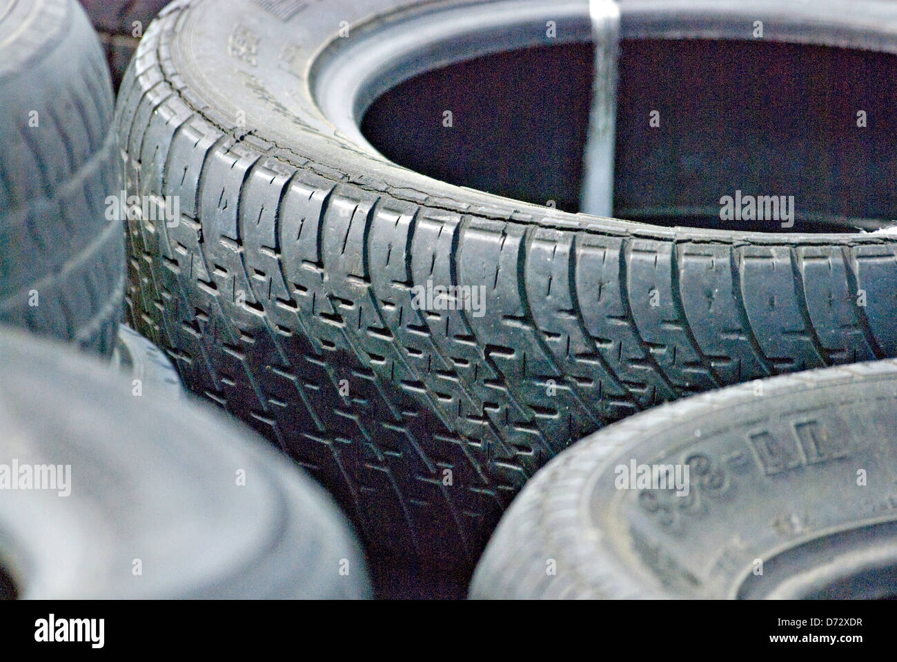 Old tires stacked together used at racing track Stock Photo - Alamy