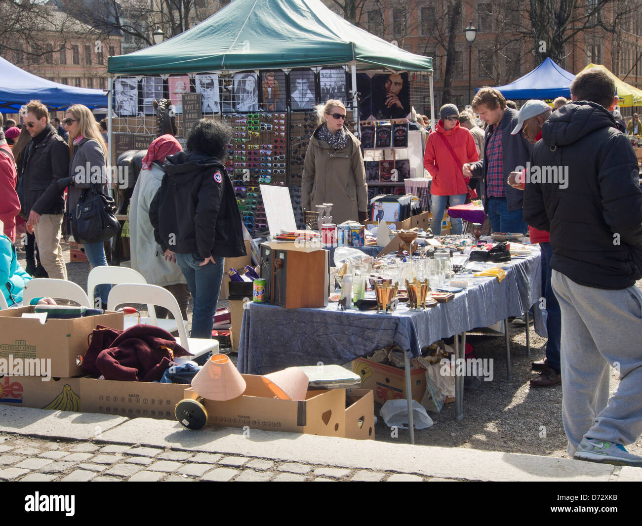Stall with varied goods, vendor and buyers in a flea market in ...