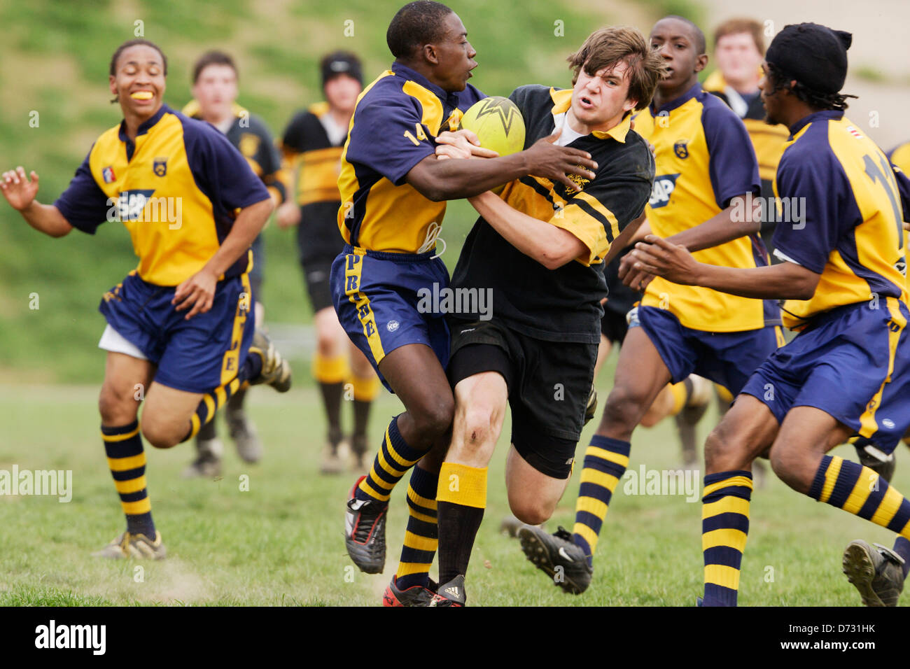 A John Carroll player (R) carries the ball against a Hyde School player ...