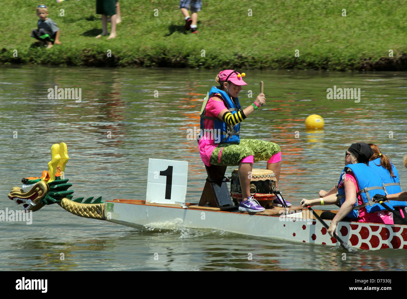 A drummer drives her team at the Ground Zero Dragon Boat Races in ...