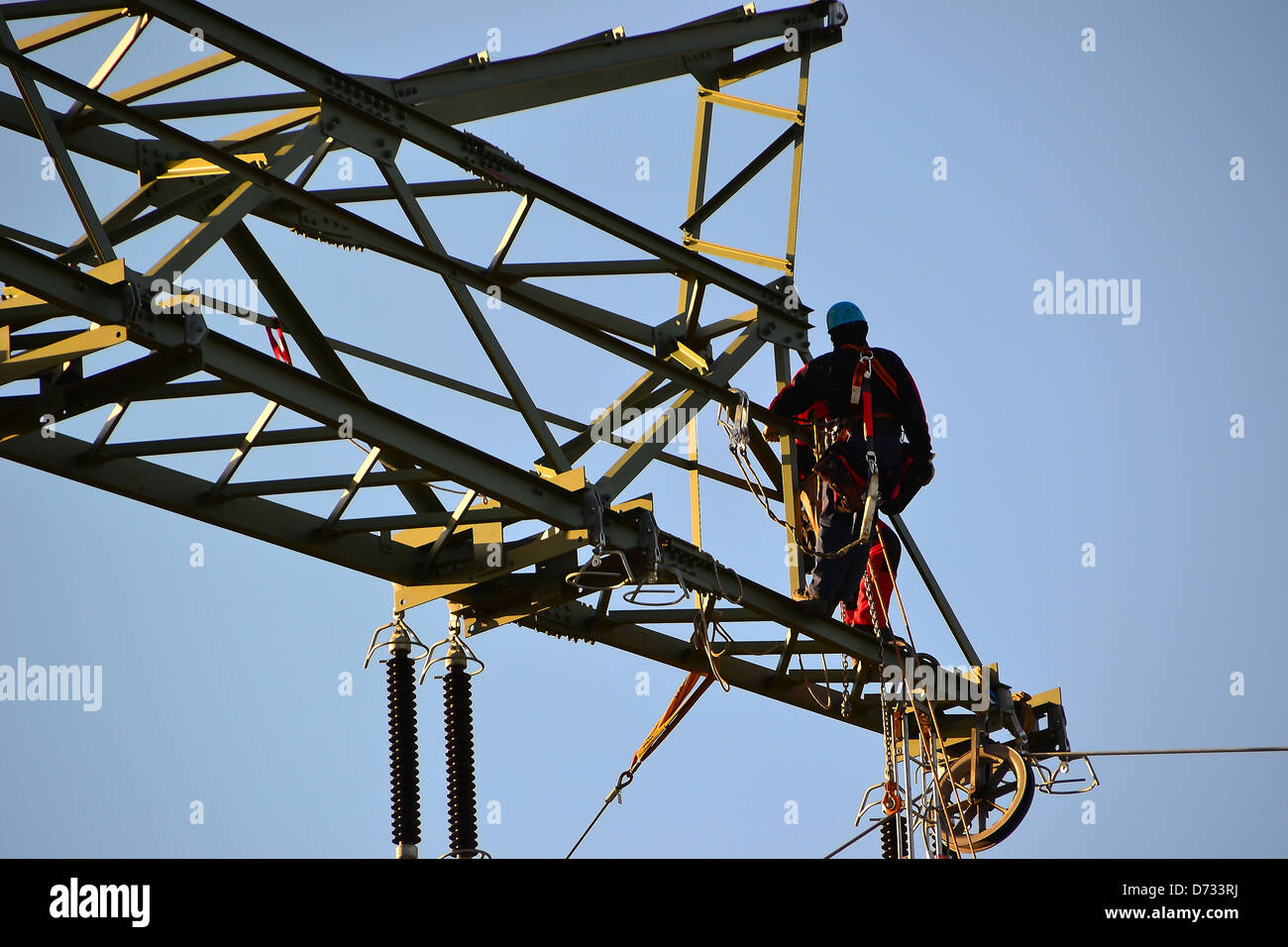 a worker in the assembly of an electricity pylon Stock Photo - Alamy