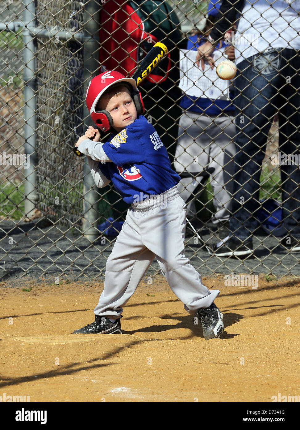a baseball player as he swings the bat at the ball Stock Photo - Alamy
