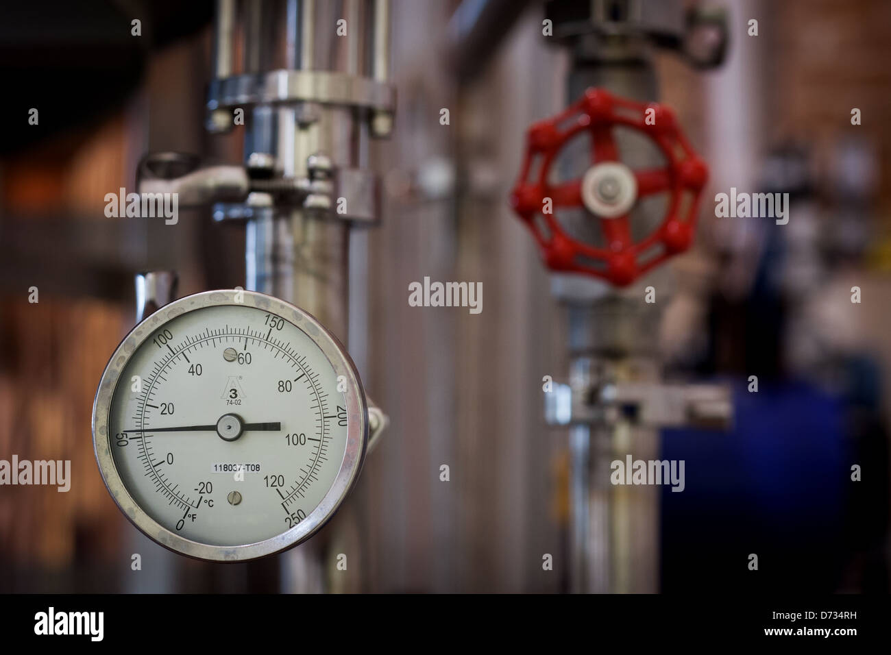 Temperature guage attached to stainless steel pipework with red valve ...