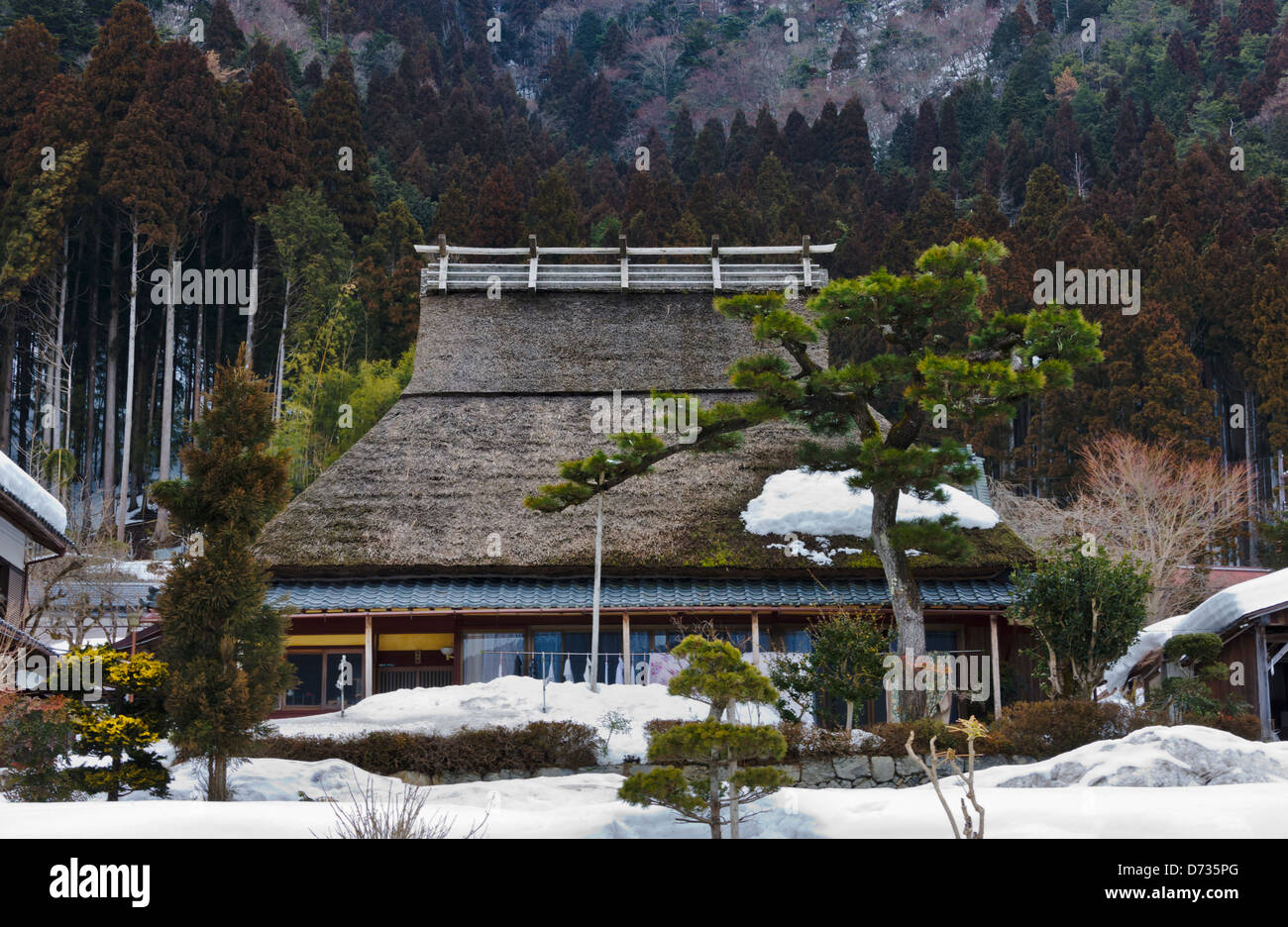 Traditional thatched roof house in the mountain covered by snow, Miyama ...