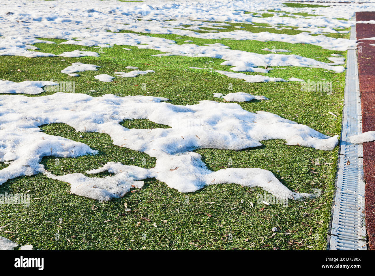 snowdrifts on outdoor soccer field in spring low season Stock Photo - Alamy