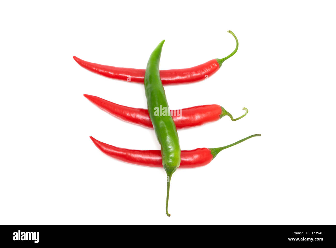 Four chili peppers on a white background Stock Photo - Alamy