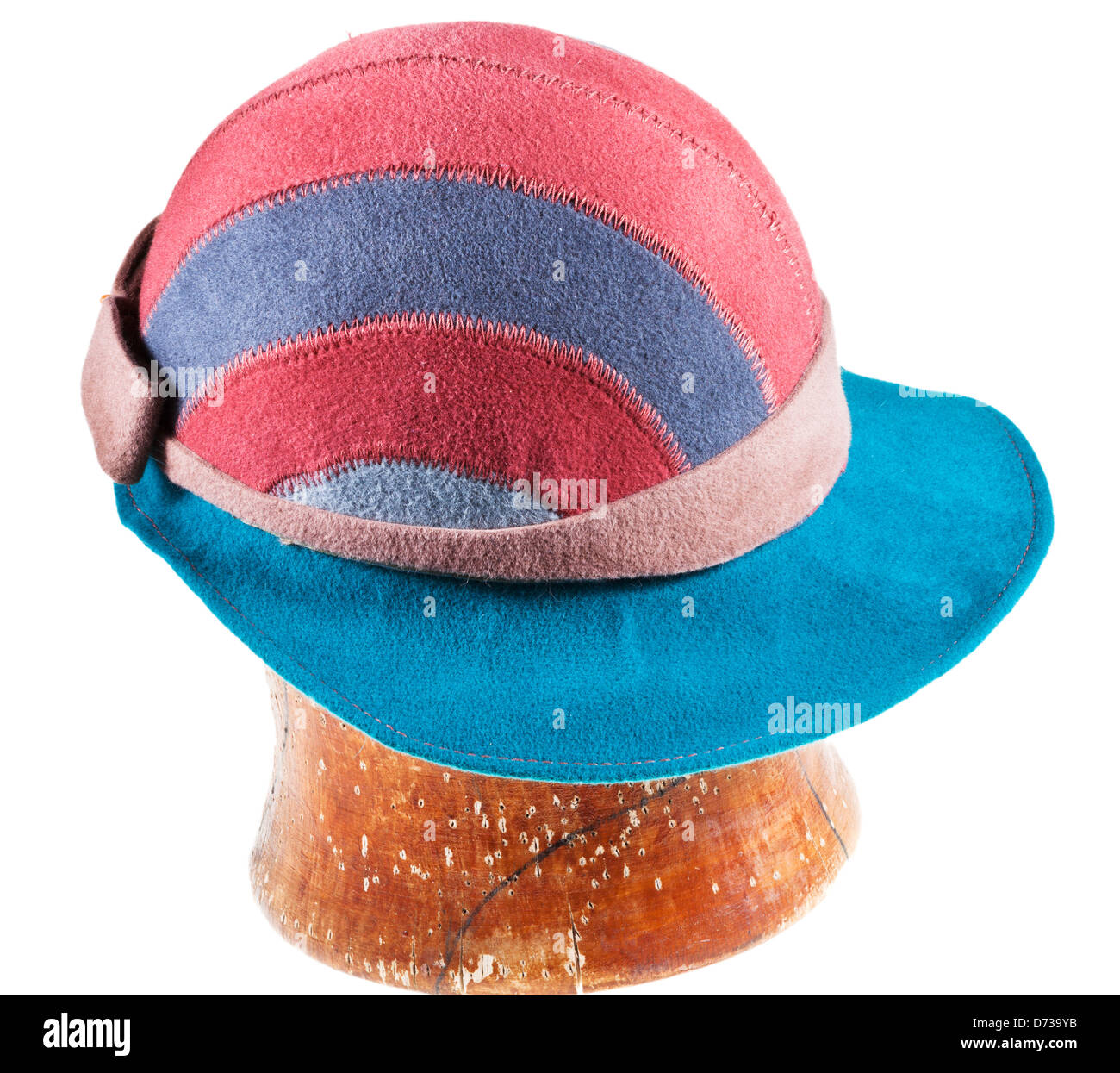 felt soft hat with wide cap peak on wooden block isolated on white ...