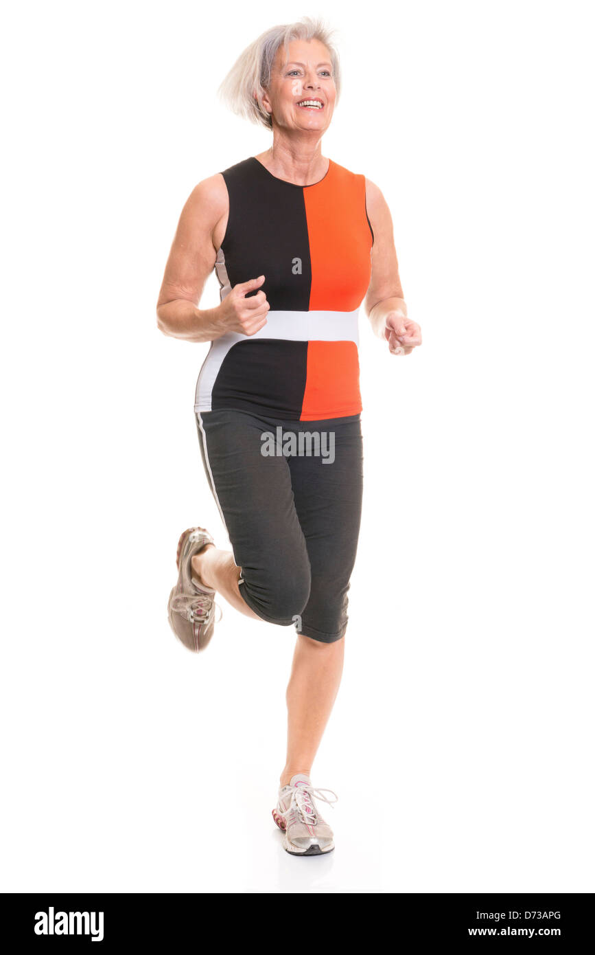 Running senior woman in front of white background Stock Photo - Alamy