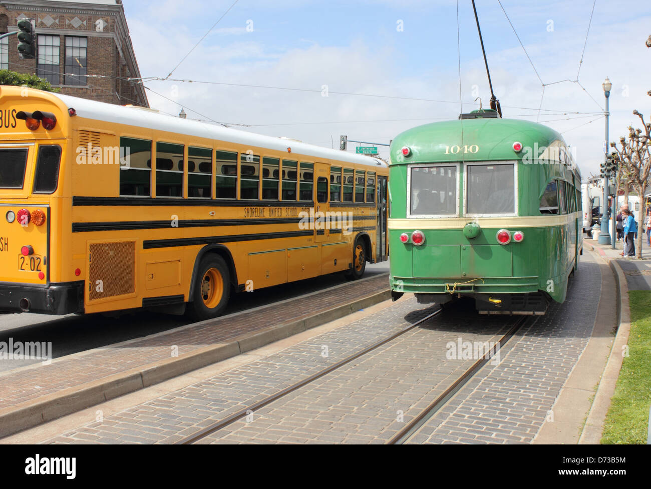 The famous public transport of trams with a modern bus alongside at ...