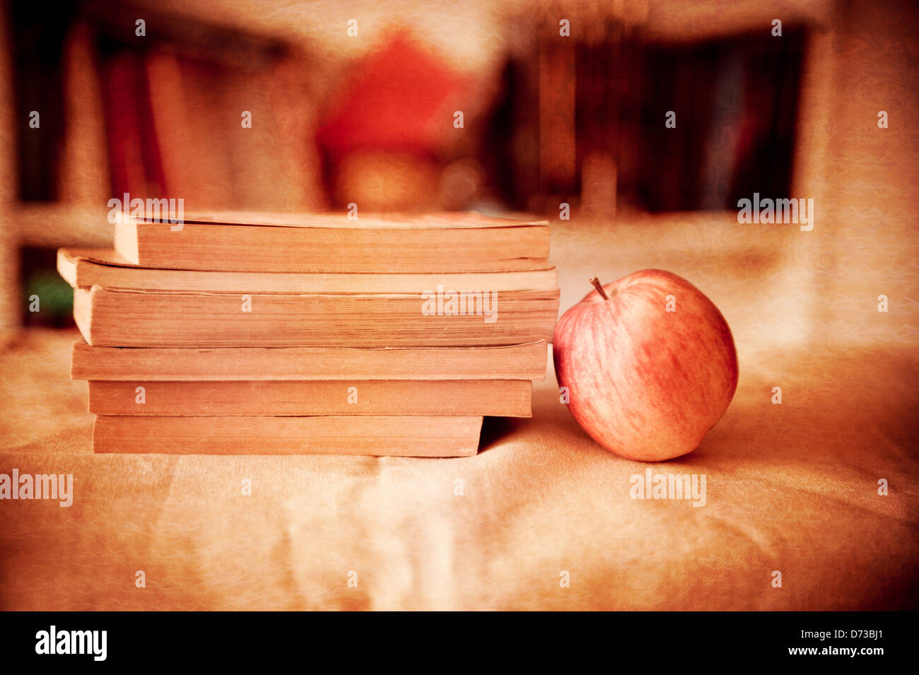 old books and one apple sepia toned still life Stock Photo - Alamy