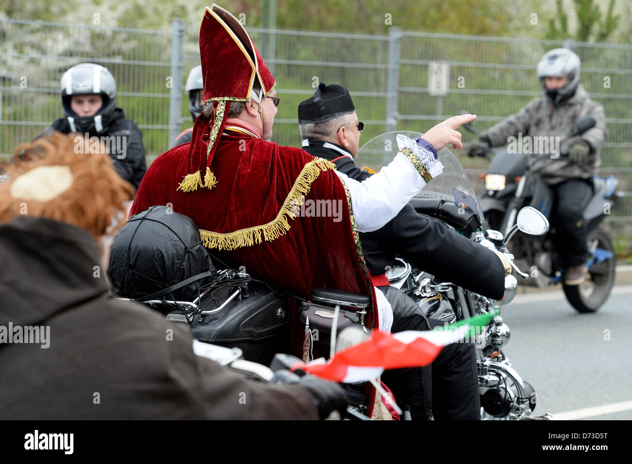 A biker dressed as pope blesses participants of the motorcycle rally in ...