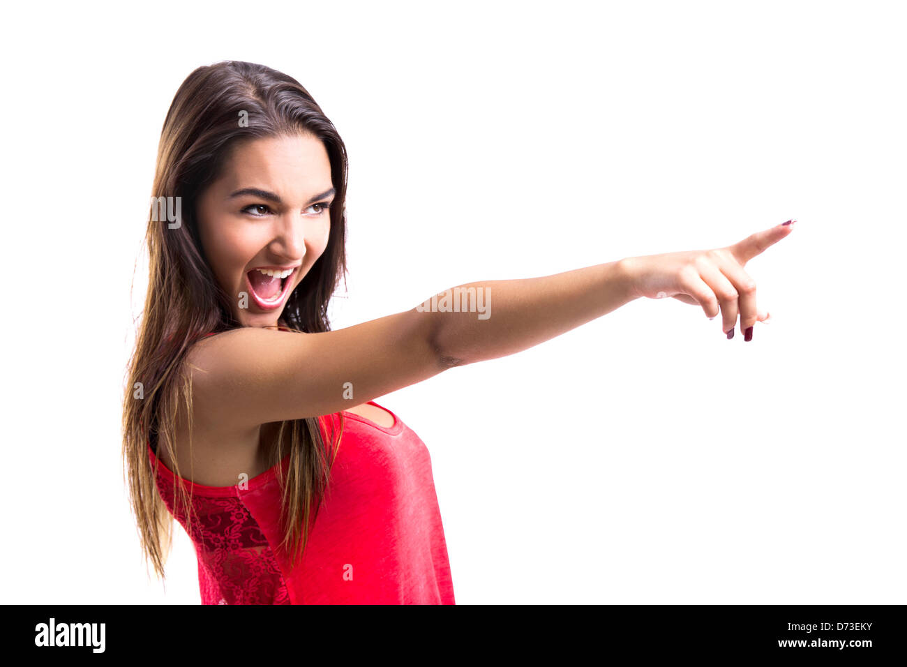 Beautiful young woman pointing to something, isolated over a white ...