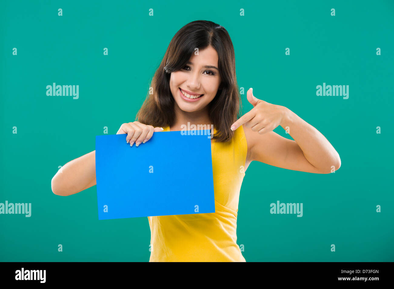 Beautiful Asian woman holding and pointing to a blue billboard, over a ...