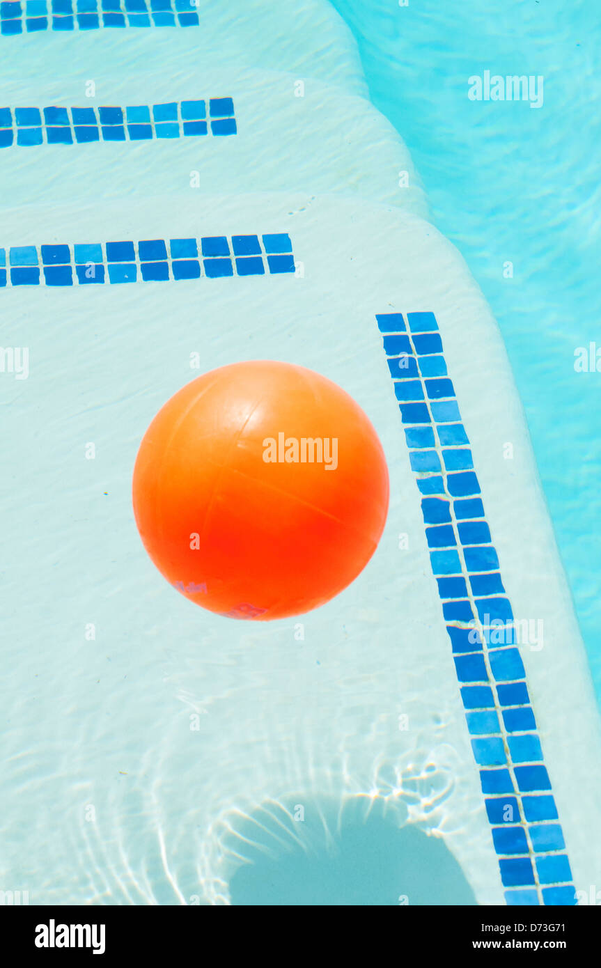 Orange ball in a swimming pool Stock Photo - Alamy