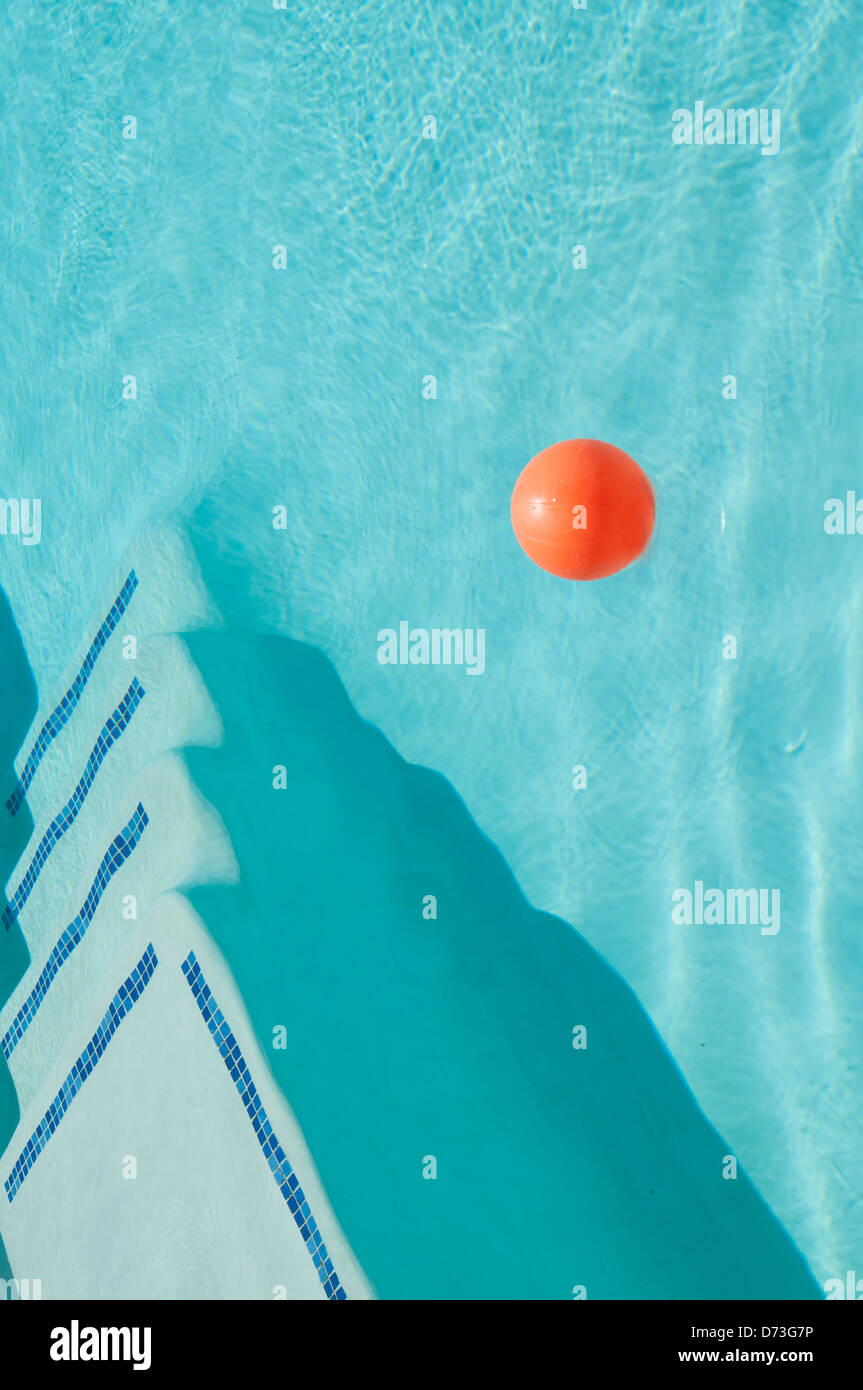 Orange ball in a swimming pool Stock Photo - Alamy