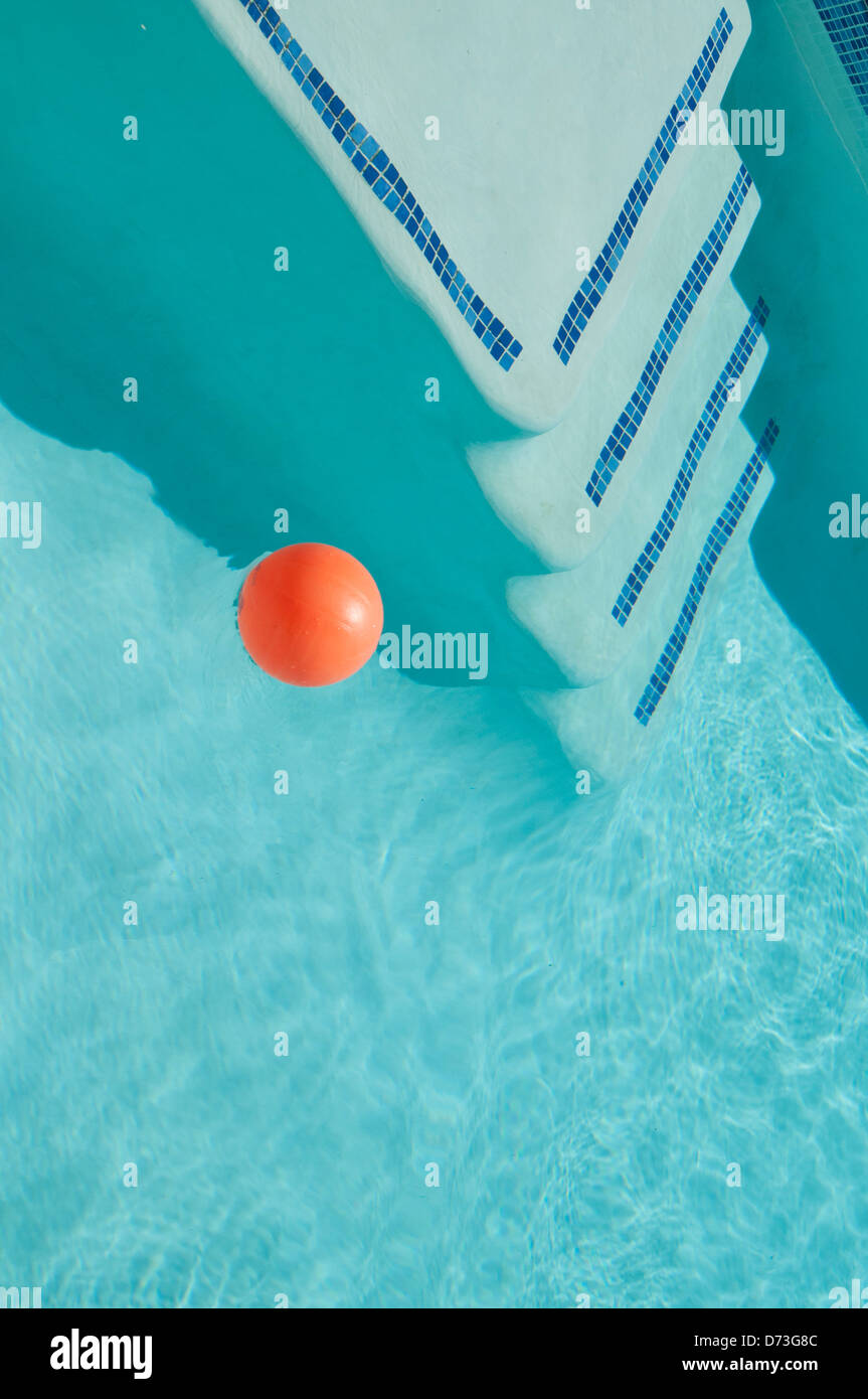Orange ball in a swimming pool Stock Photo - Alamy