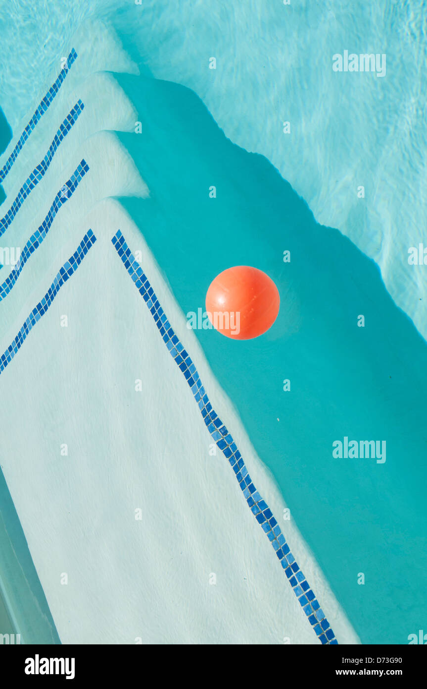 Orange ball in a swimming pool Stock Photo - Alamy