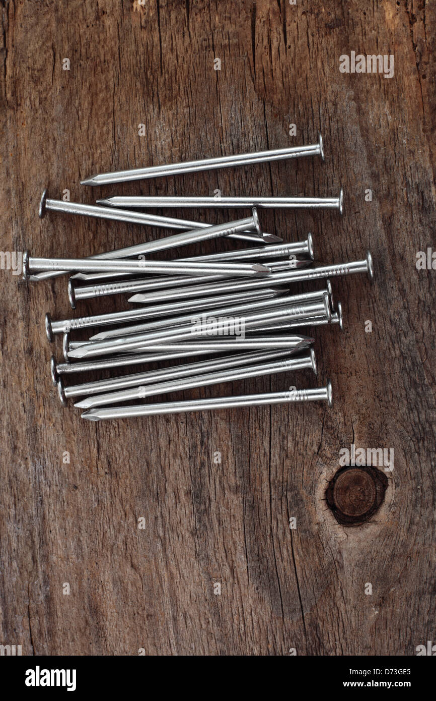 Steel 2 inch nails on a wooden background. New and unused Stock Photo ...