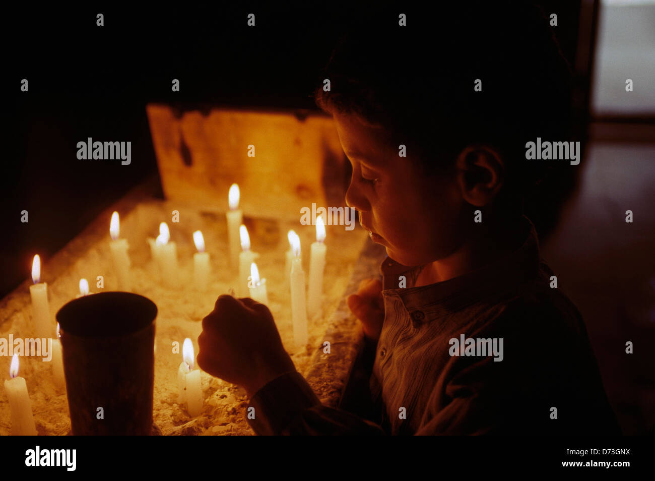A Syrian boy lights candles at the local church in Maaloula during the ...