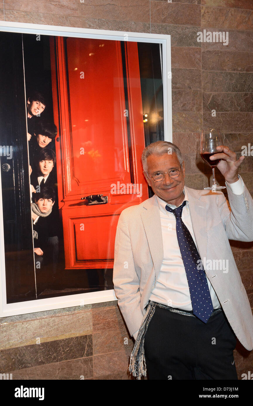 French photographer Jean-Marie Perier raises a glass as he poses in ...