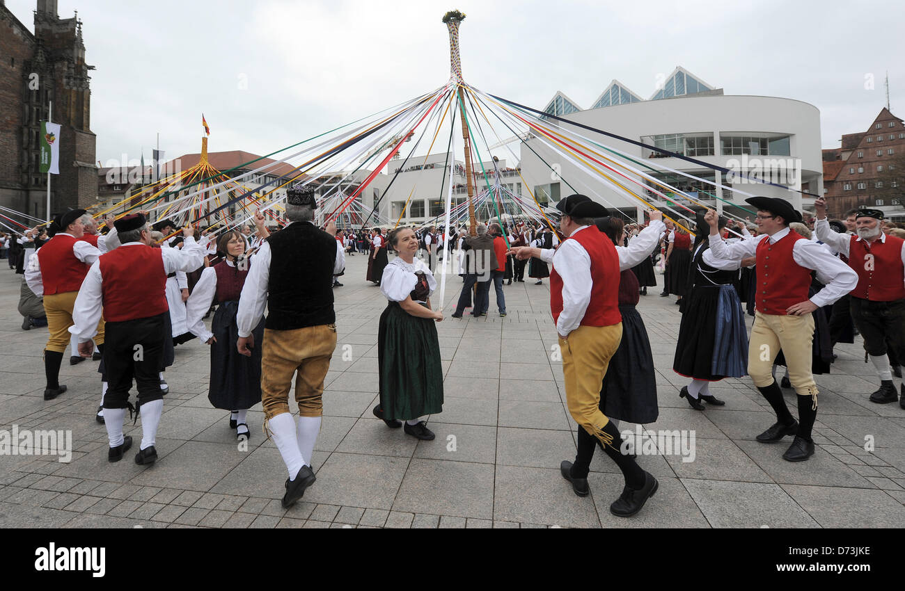 People in traditional costumes perform a maypole dance in Ulm, Germany ...