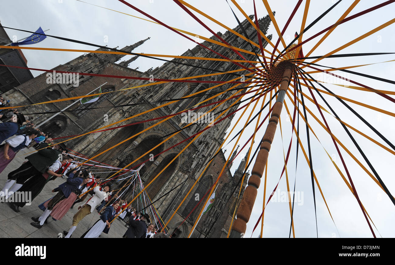 People in traditional costumes perform a maypole dance in Ulm, Germany ...