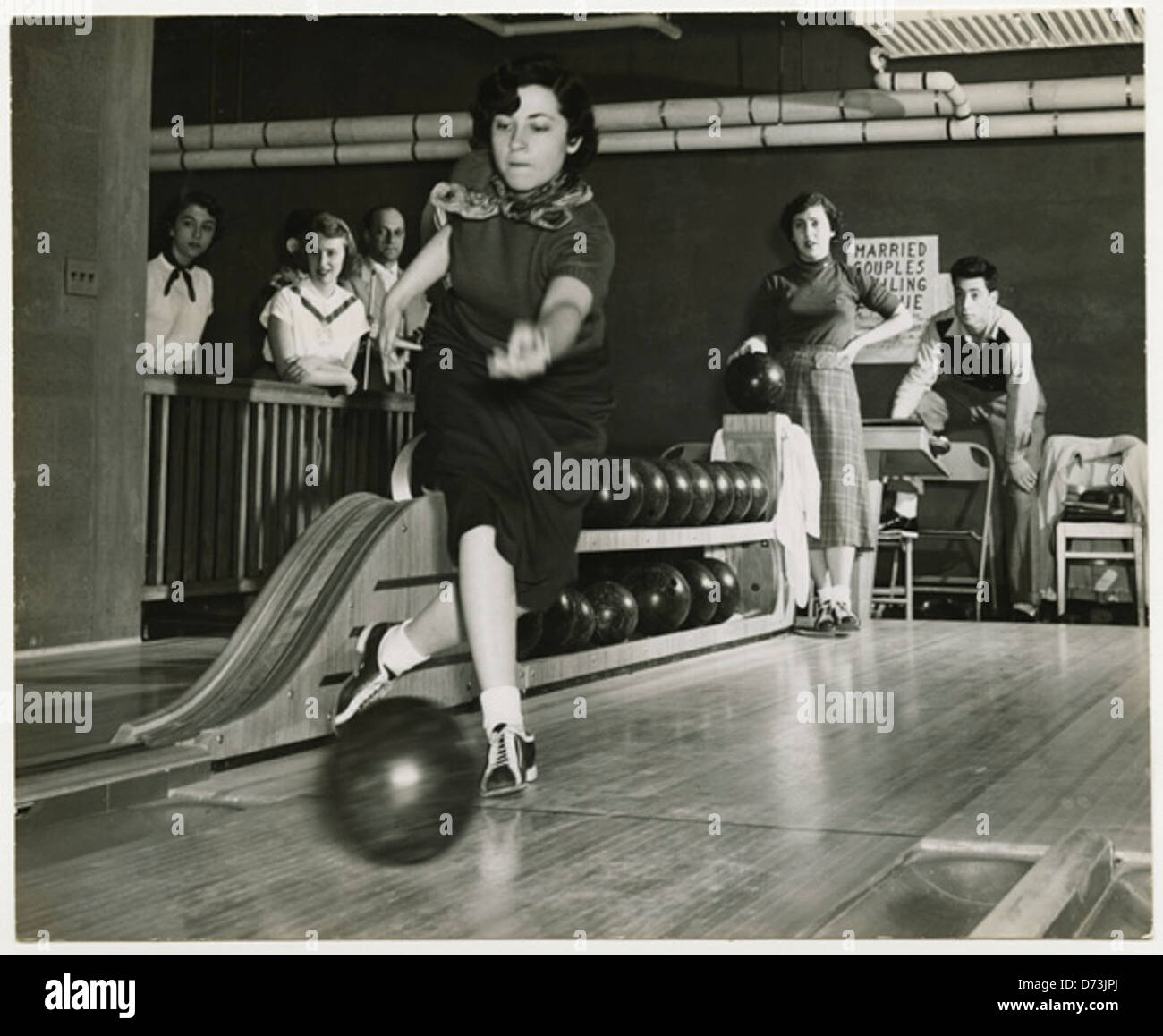 A photograph of a woman bowling in the 1950s, part of a recreational ...