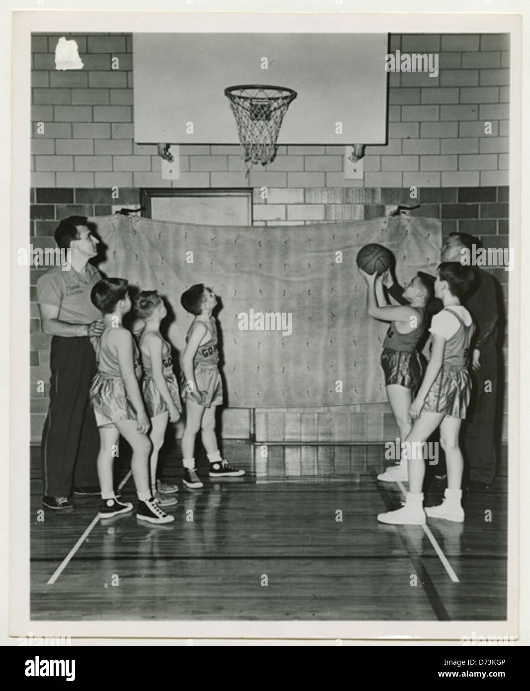 A Jewish boy aims at a basketball hoop in this photograph from the ...